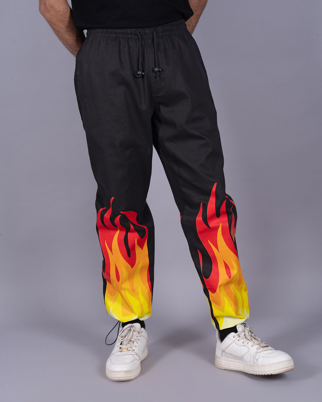 Buy Men's Black & Yellow Fire Printed Oversized Parachute Pants Online ...